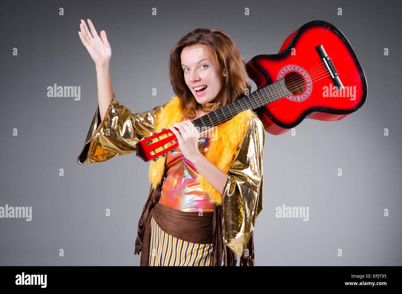 Guitar player with red instrument Stock Photo - Alamy