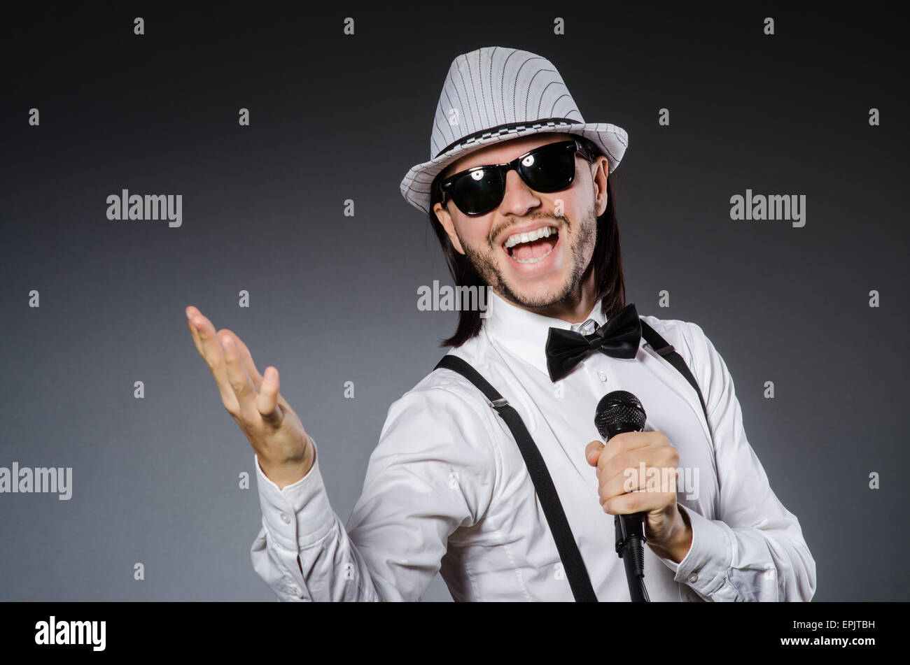 Funny singer with microphone at the concert Stock Photo - Alamy