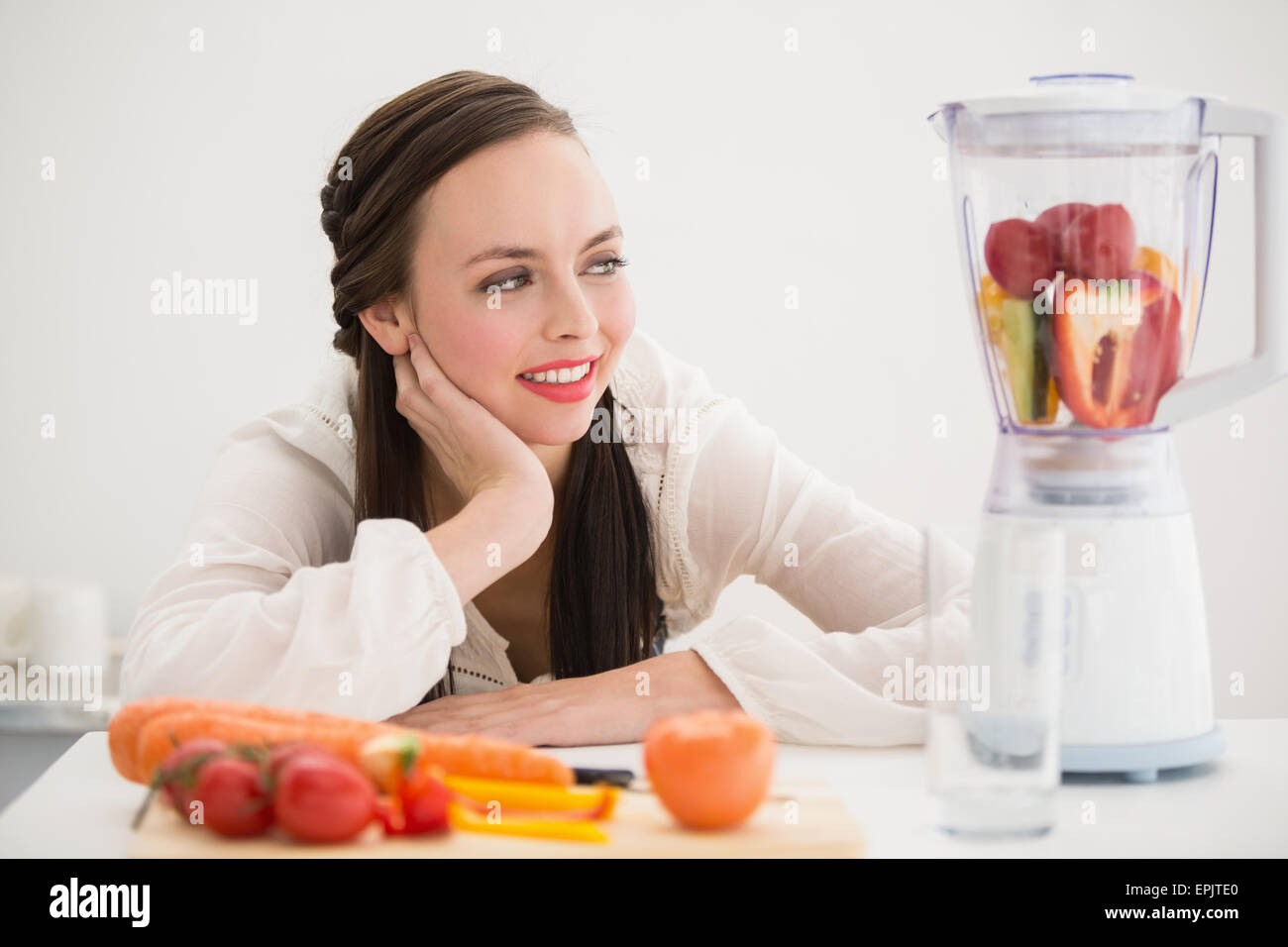 Pretty brunette preparing a healthy juice Stock Photo - Alamy