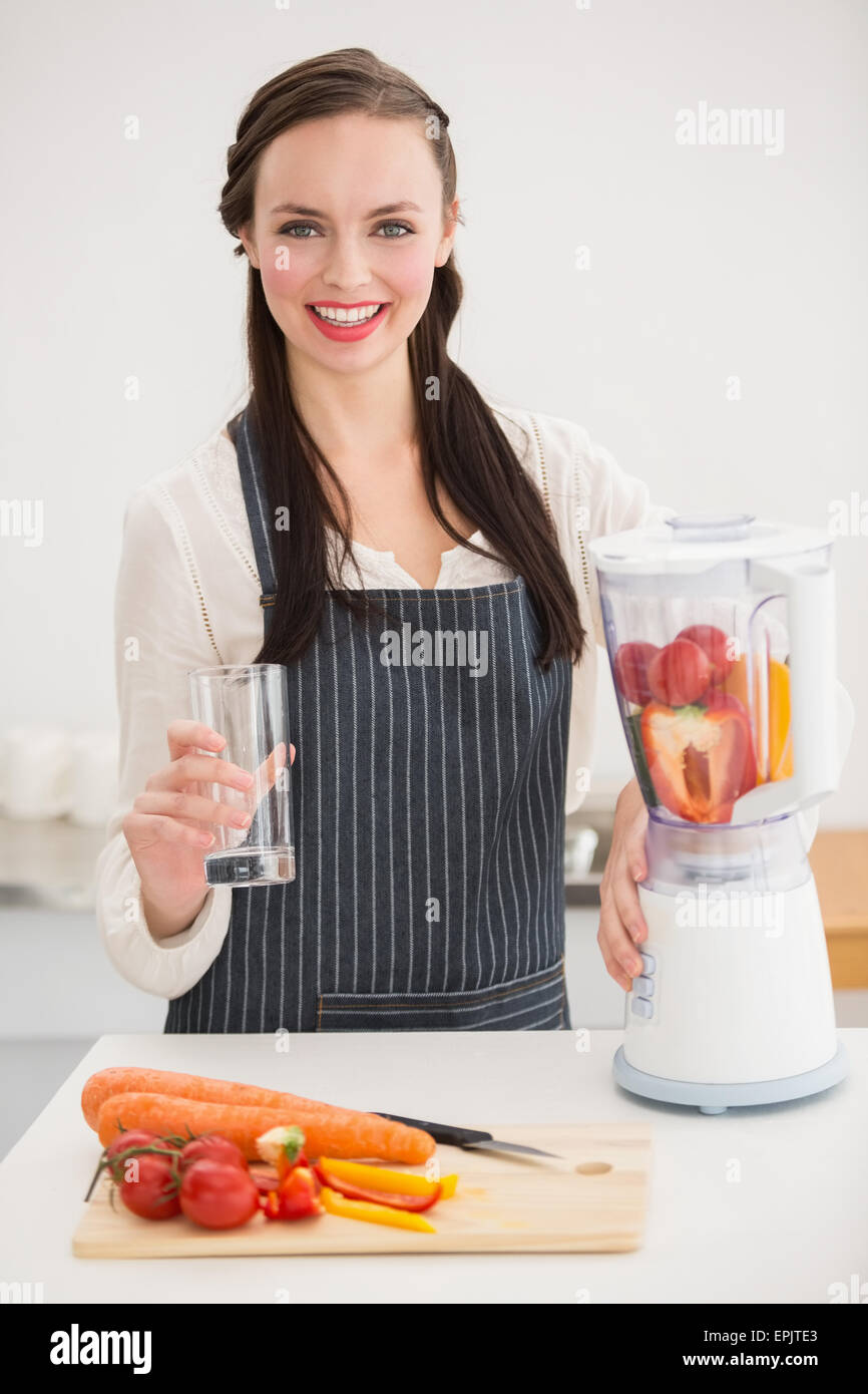 Pretty brunette preparing a healthy juice Stock Photo - Alamy