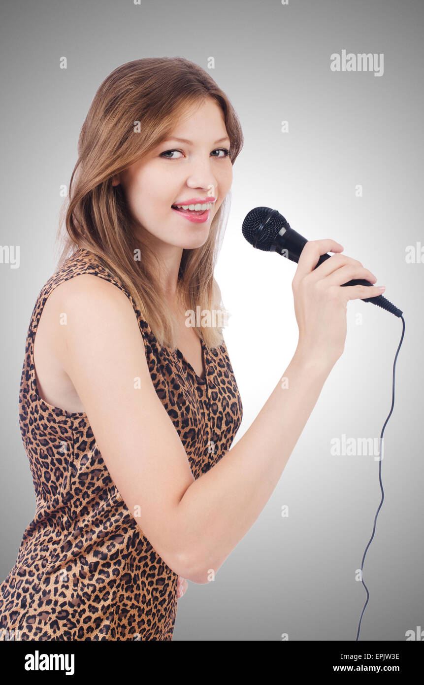 Woman singer with microphone on white Stock Photo - Alamy