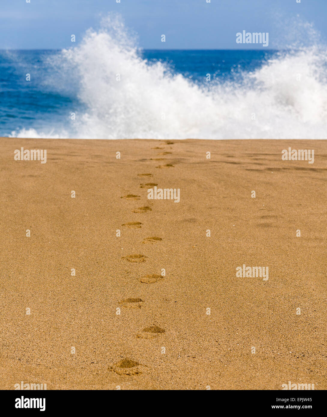 Sandy beach with footsteps to water Stock Photo - Alamy