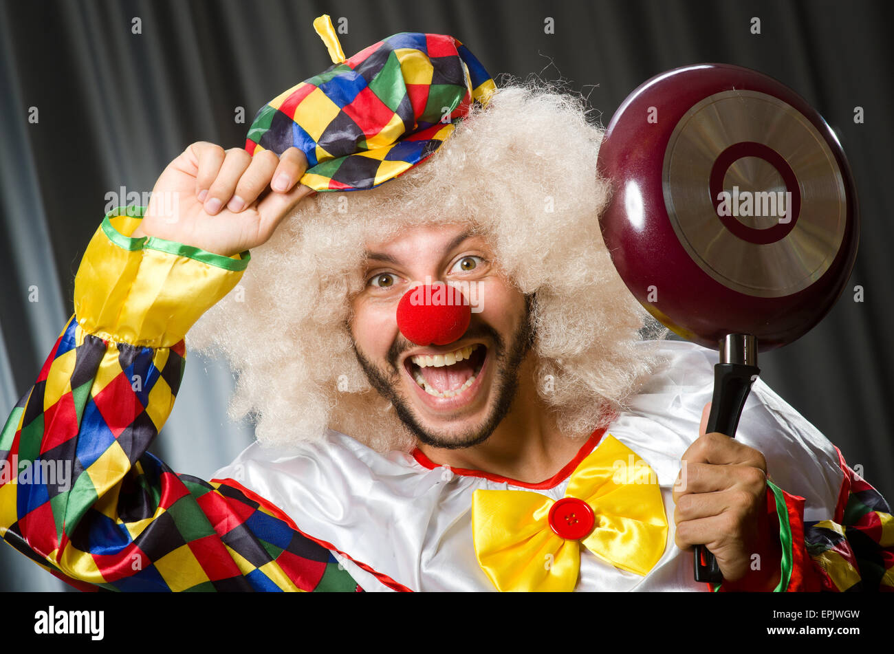 Angry clown with frying pan Stock Photo - Alamy