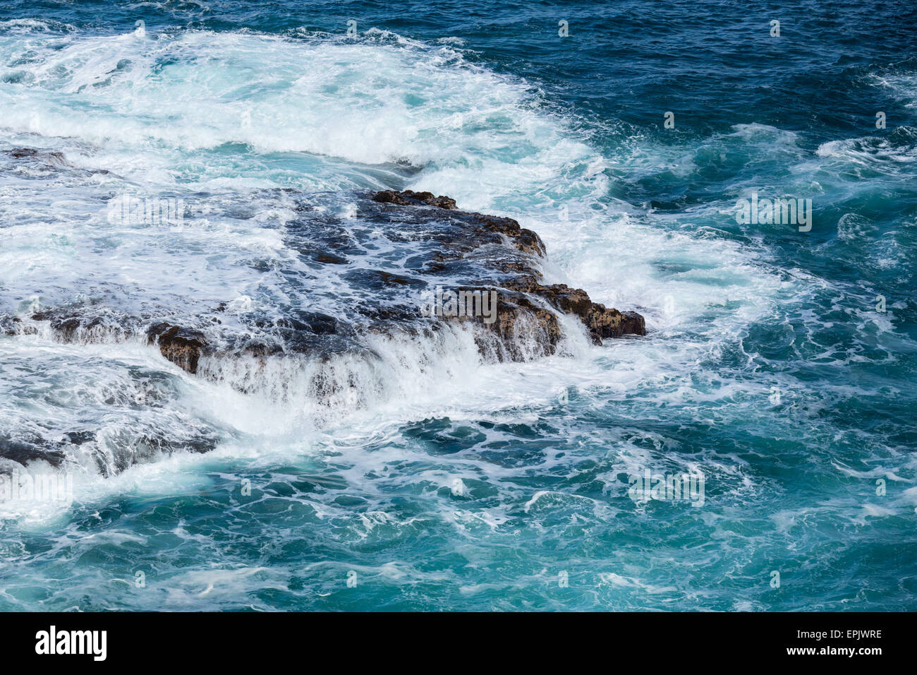 Raging sea flows over lave rocks on shore line Stock Photo - Alamy