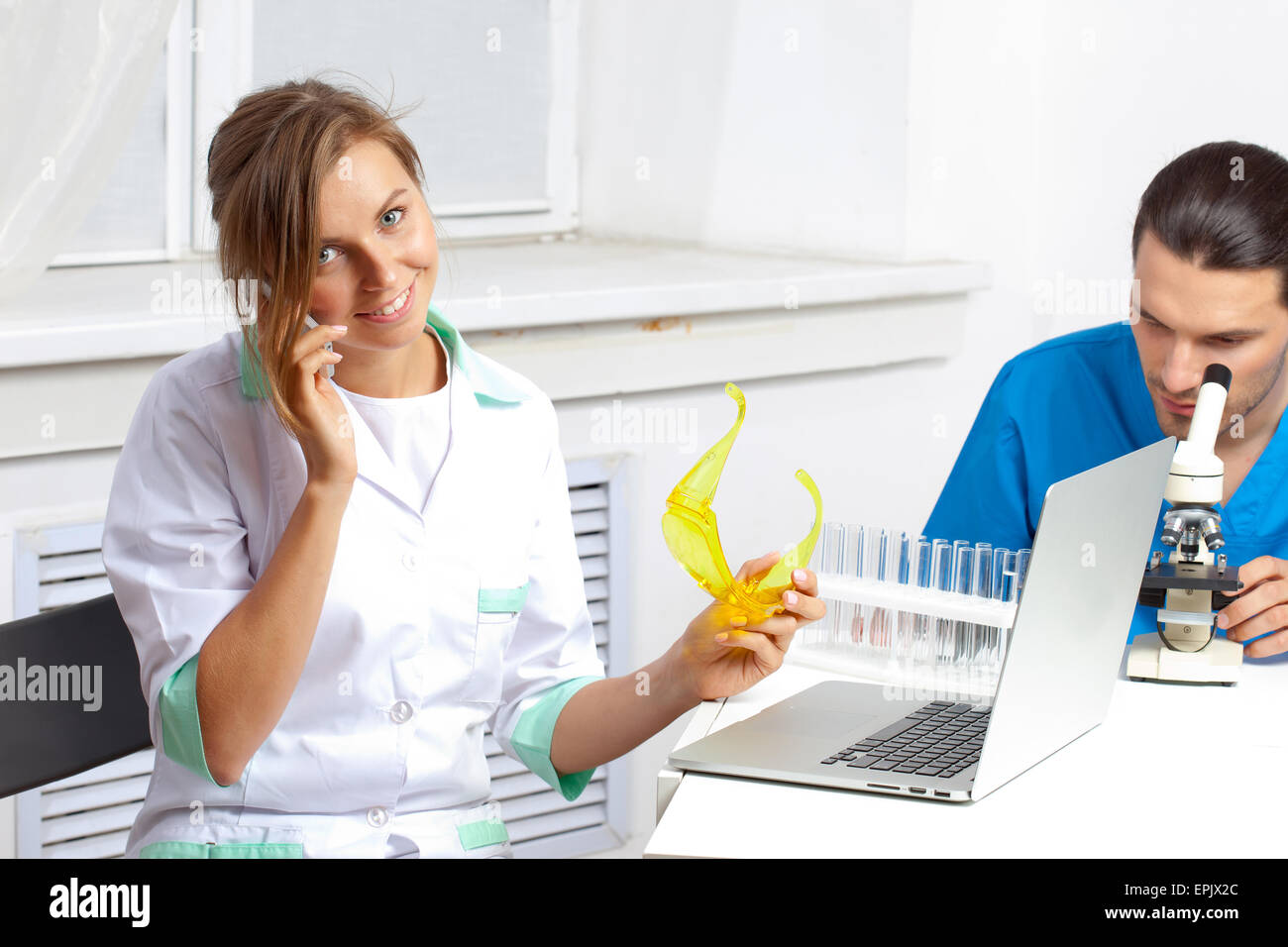 Doctor talking on a cell phone in lab Stock Photo - Alamy