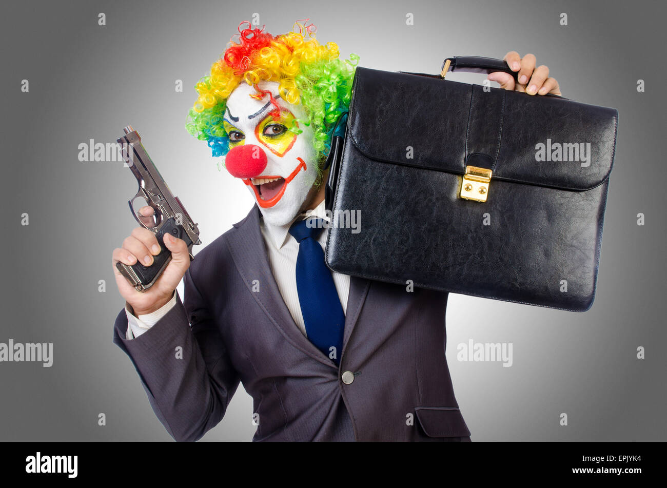 Businessman clown with gun isolated on white Stock Photo - Alamy