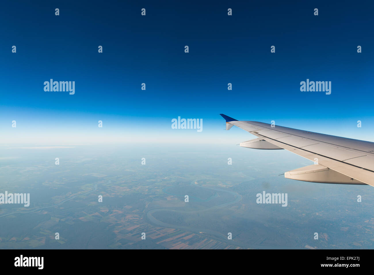 Airplane wing out of window Stock Photo - Alamy