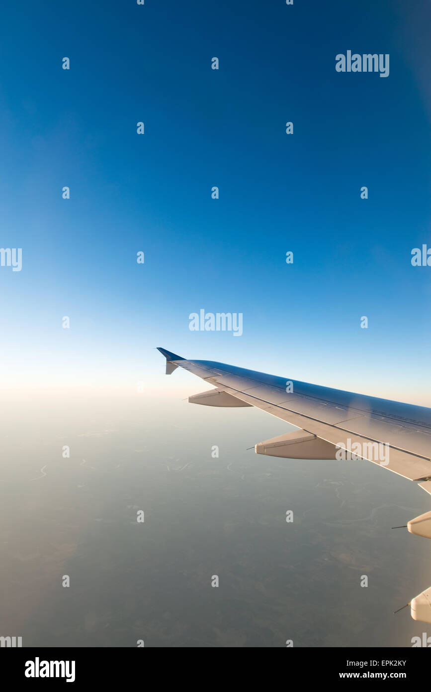 Airplane wing out of window Stock Photo - Alamy