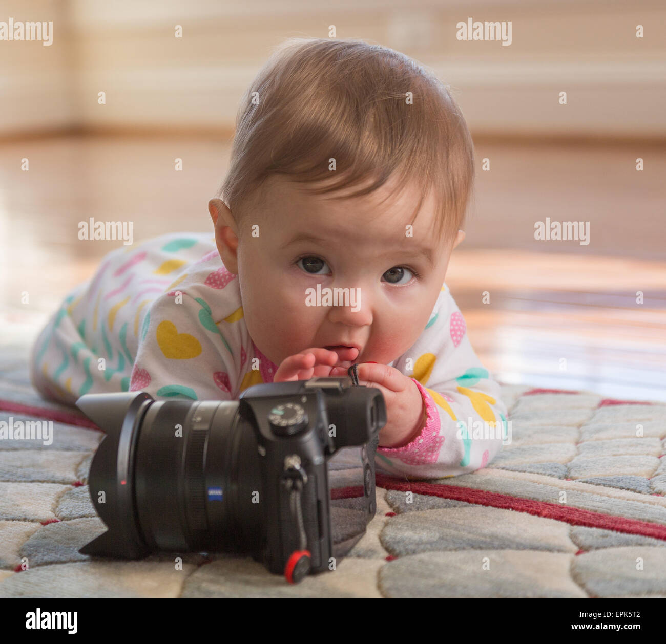 Young baby girl playing with camera Stock Photo - Alamy