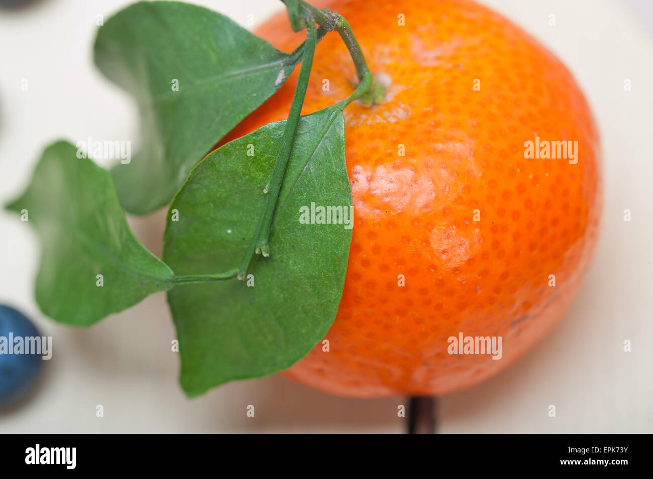 tangerine and blueberry on white table Stock Photo - Alamy