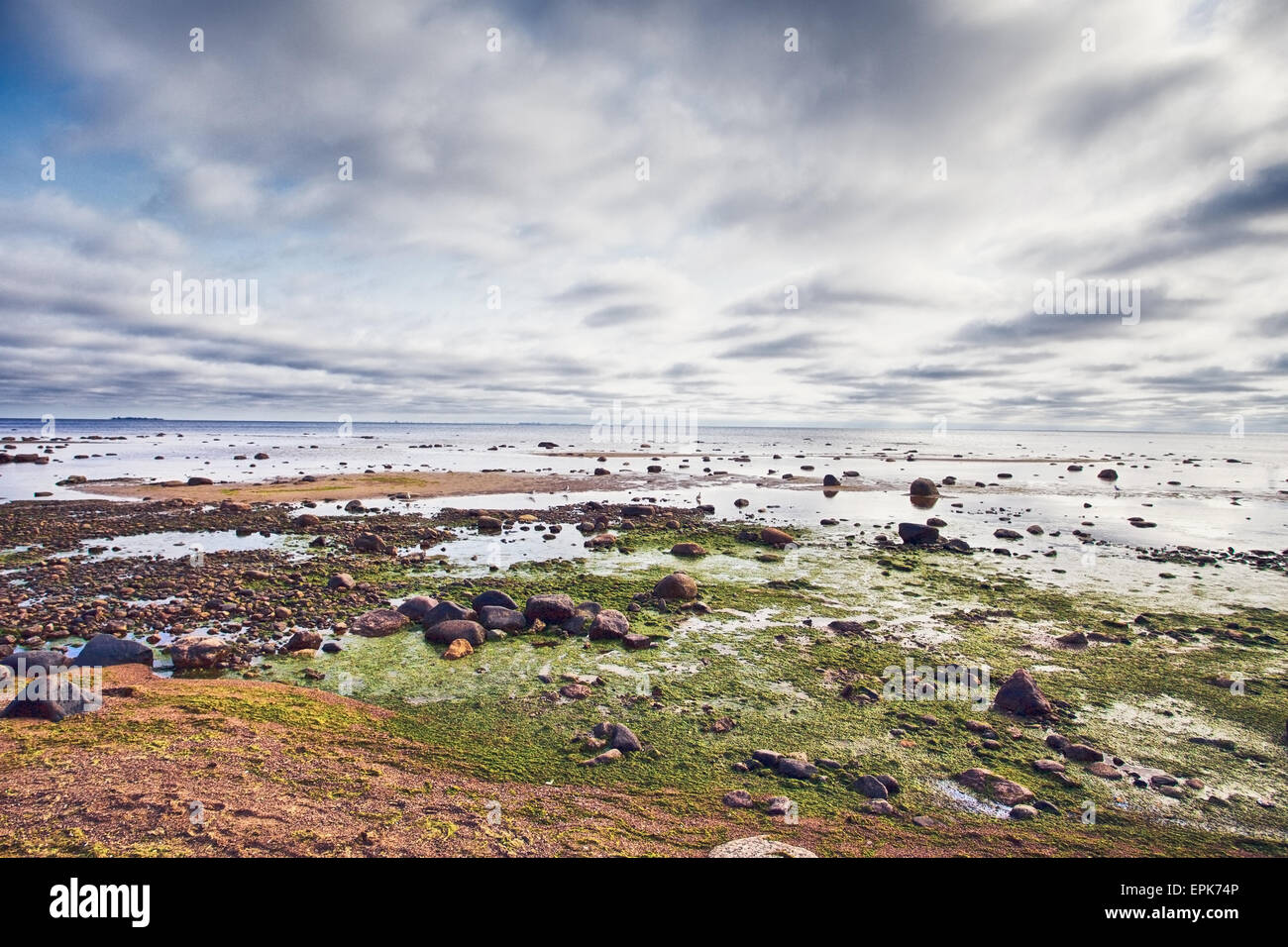 low tide at sea at dramatic cloudy day Stock Photo - Alamy