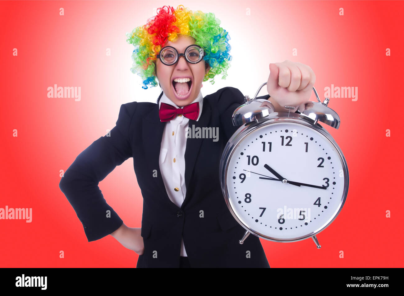 Funny clown with clock on white Stock Photo - Alamy