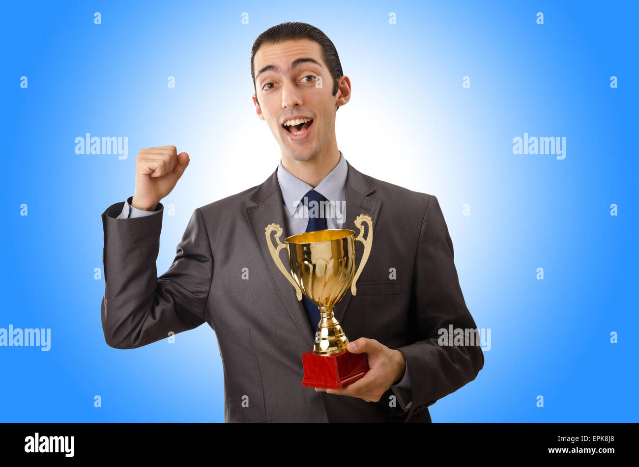 Man being awarded with golden cup Stock Photo - Alamy