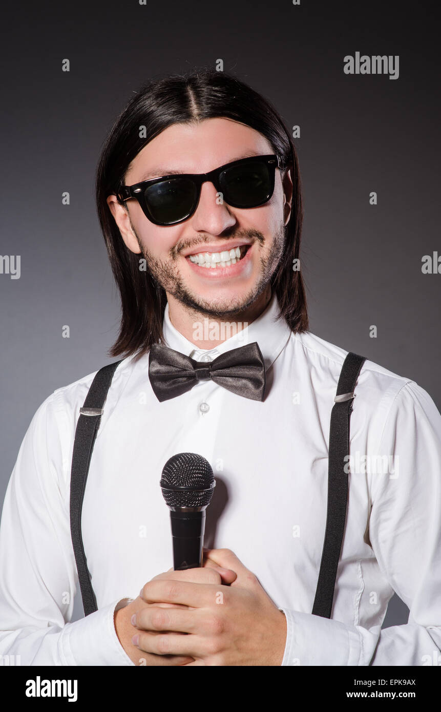 Funny singer with microphone at the concert Stock Photo - Alamy