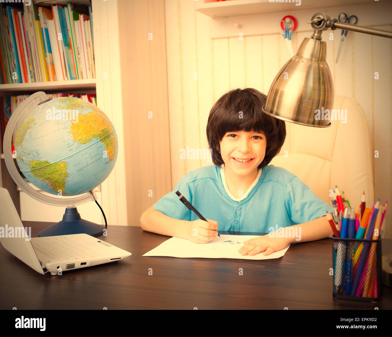 smiling schoolboy doing homework Stock Photo - Alamy