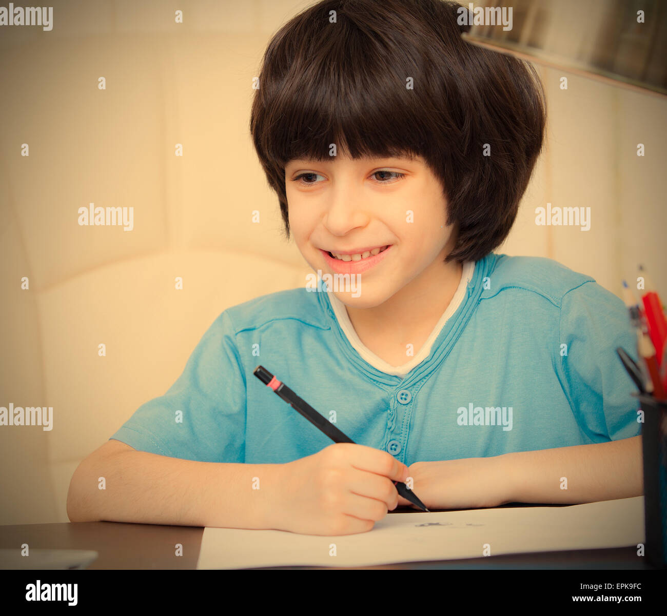 smiling child doing homework with computer Stock Photo - Alamy