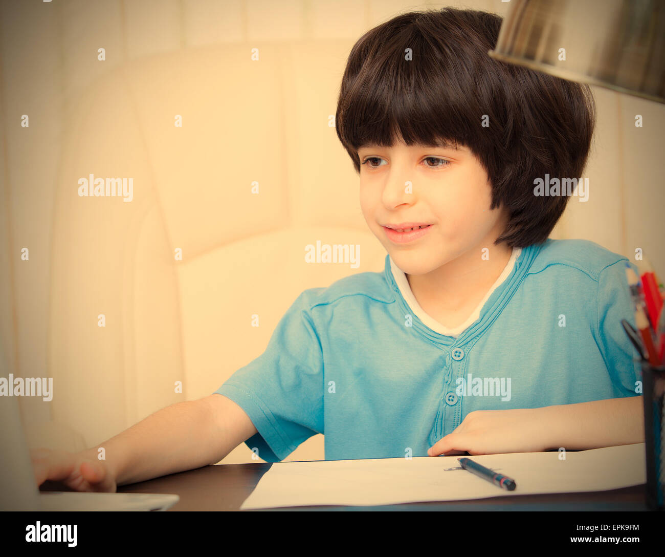 boy doing homework with computer Stock Photo - Alamy