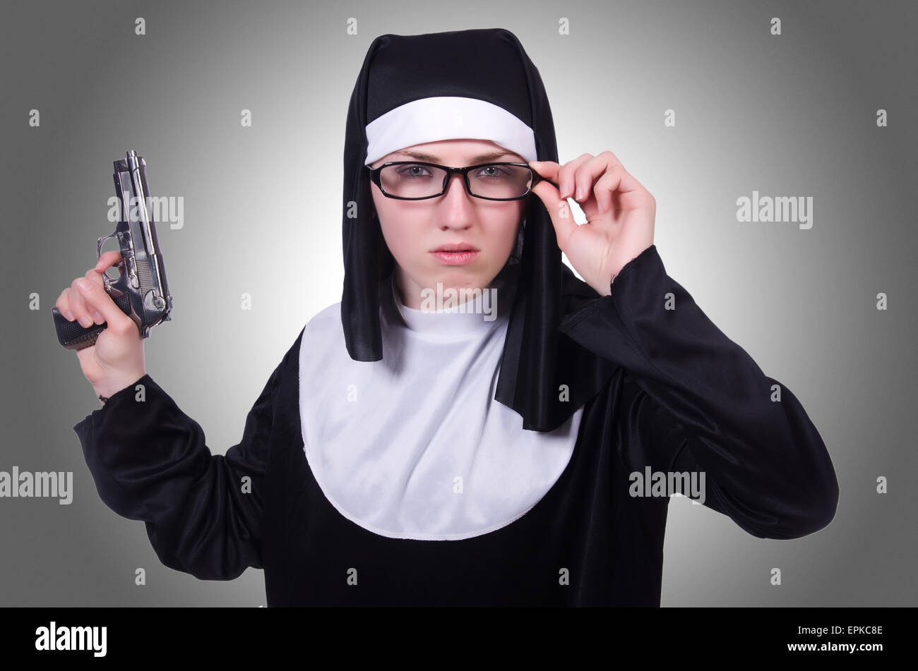 Nun with handgun isolated on white Stock Photo - Alamy