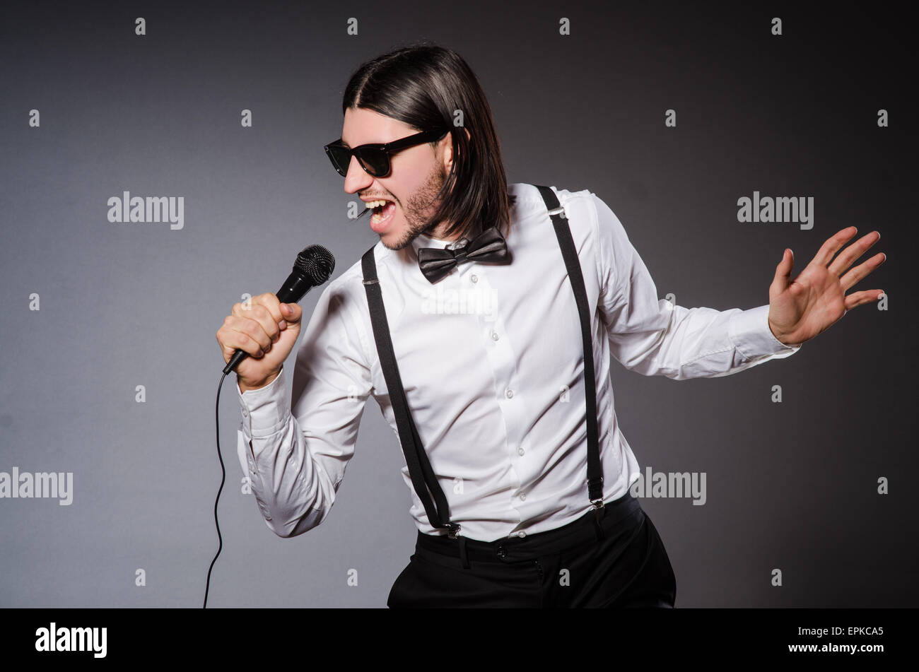 Funny singer with microphone at the concert Stock Photo - Alamy