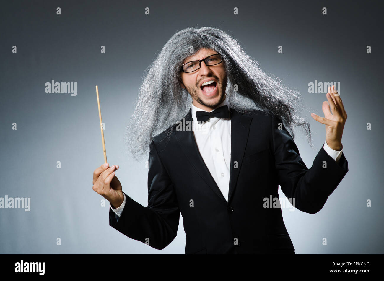 Funny conductor with long grey hair Stock Photo - Alamy