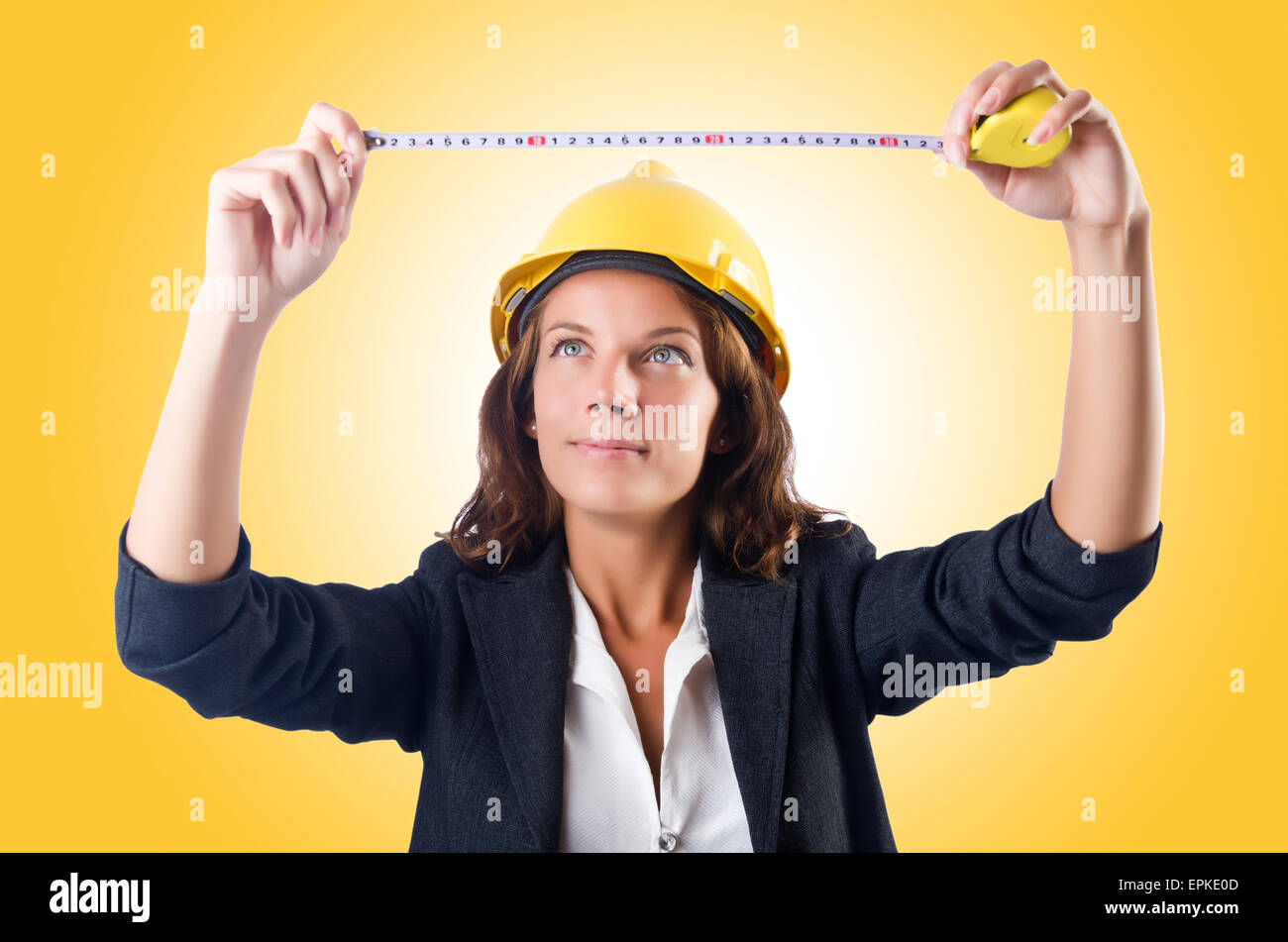 Woman builder with measuring tape Stock Photo - Alamy