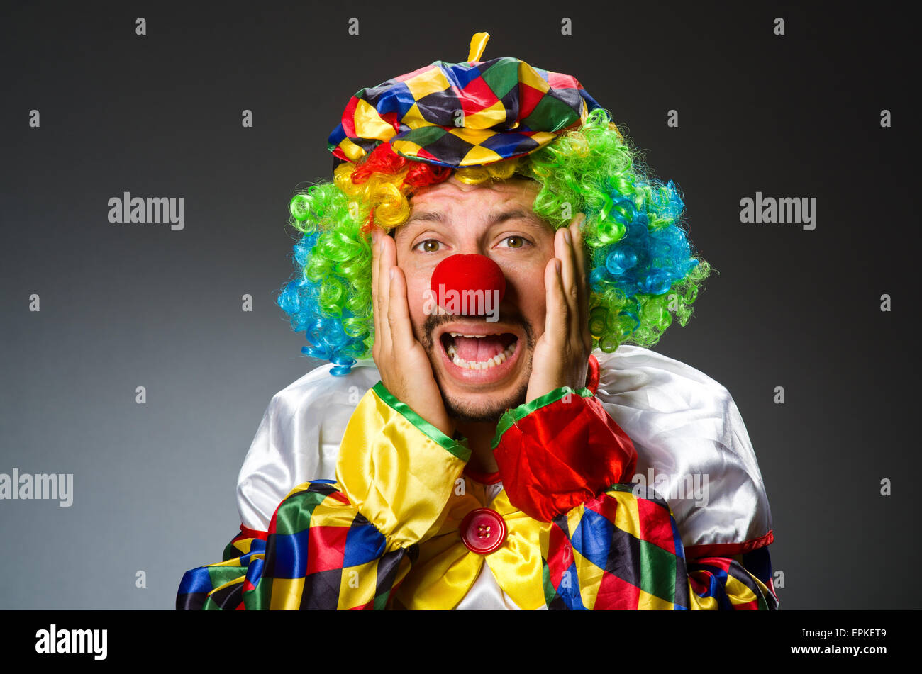 Funny clown in colourful costume Stock Photo - Alamy