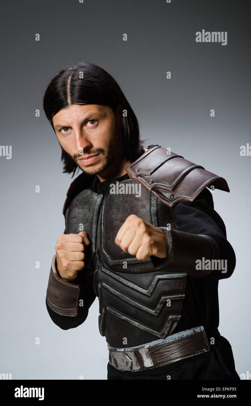 Angry warrior against dark background Stock Photo - Alamy