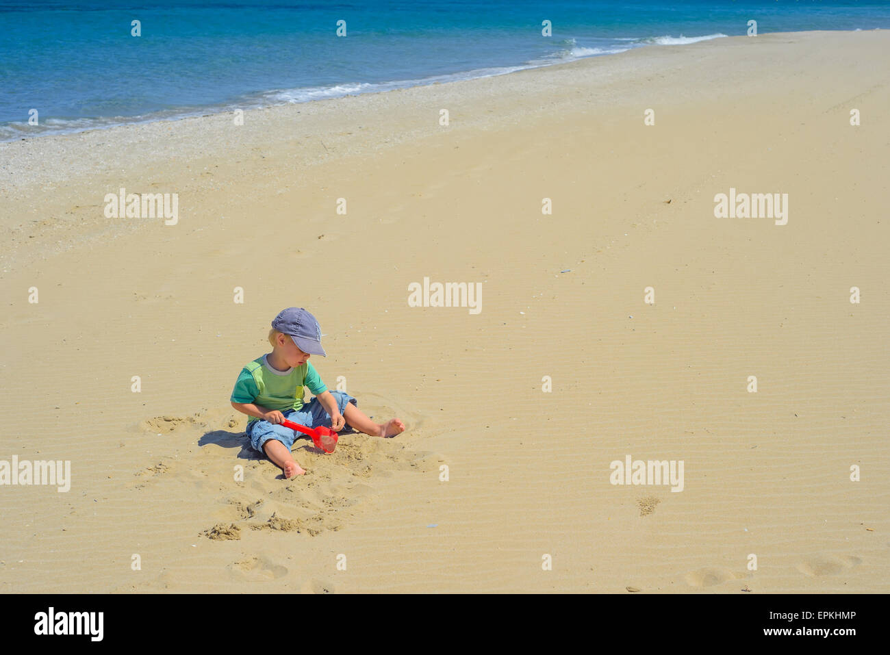 Little boy playing with sand Stock Photo - Alamy