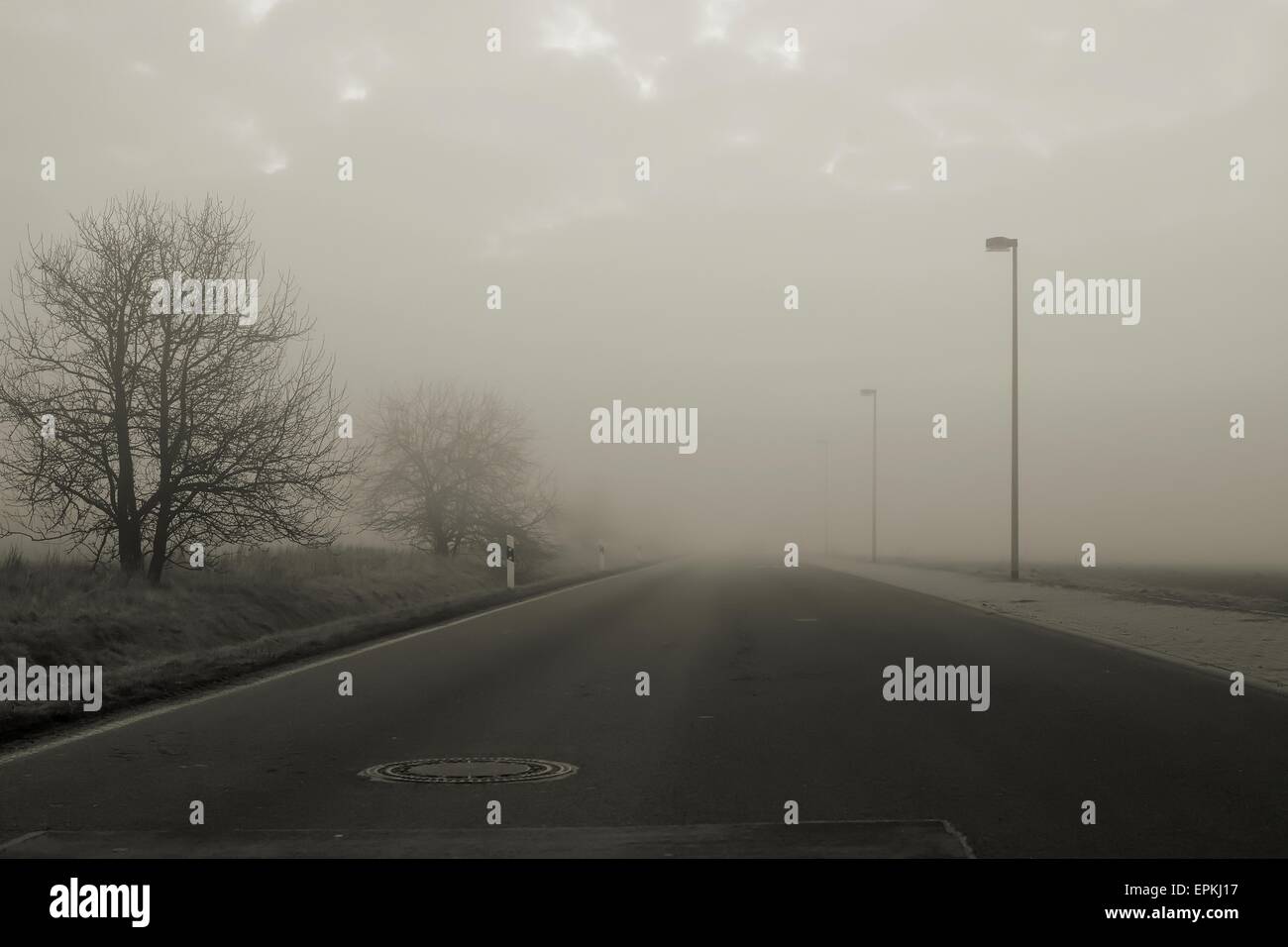 Dark foggy country road hi-res stock photography and images - Alamy