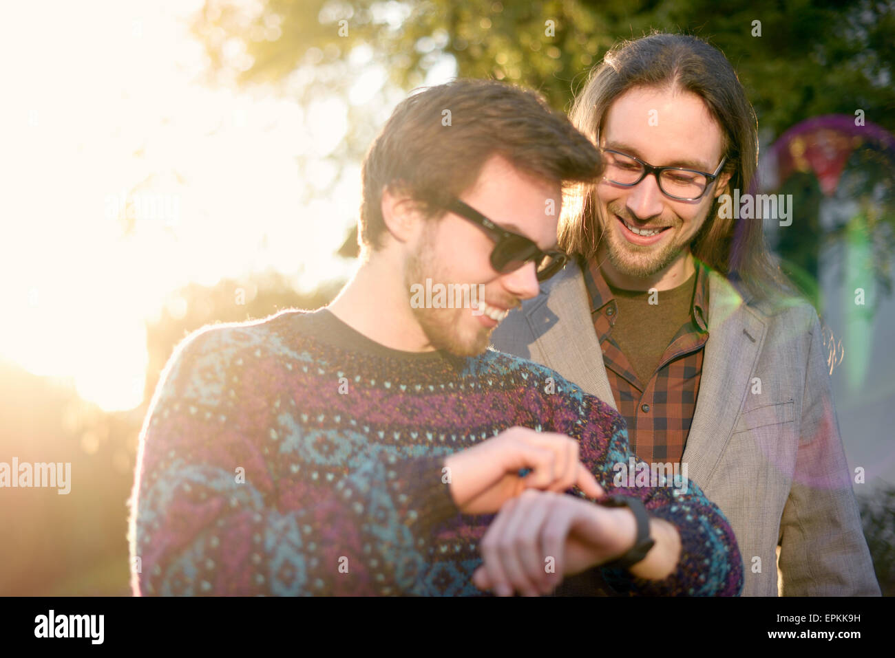 Two hipsters with a smartwatch Stock Photo - Alamy