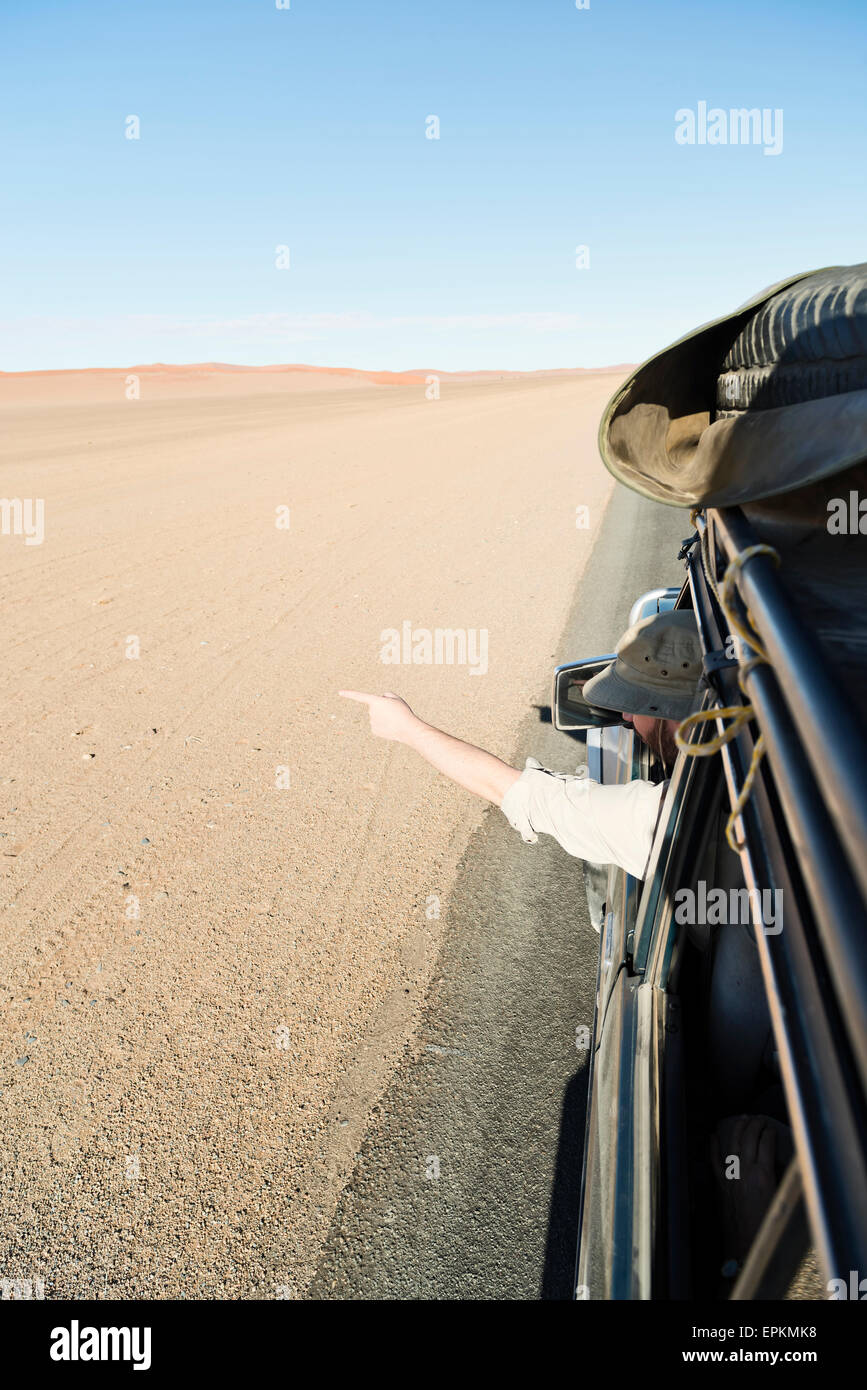 Namibia, Namib Desert, Namib Naukluft Park, Sossusvlei, man in a car ...