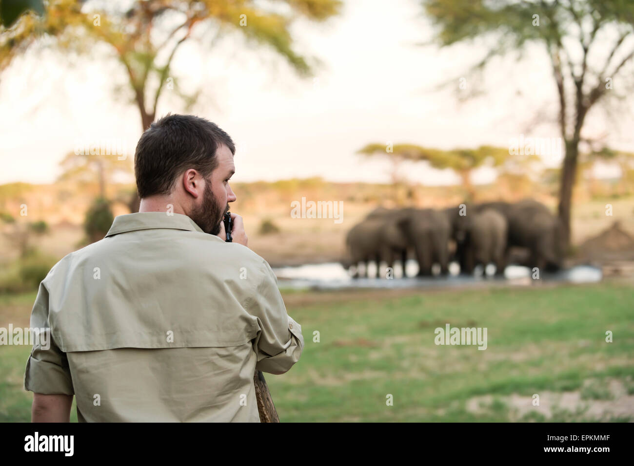 Botswana, Senyati Safari Camp, Man taking pictures of group of ...