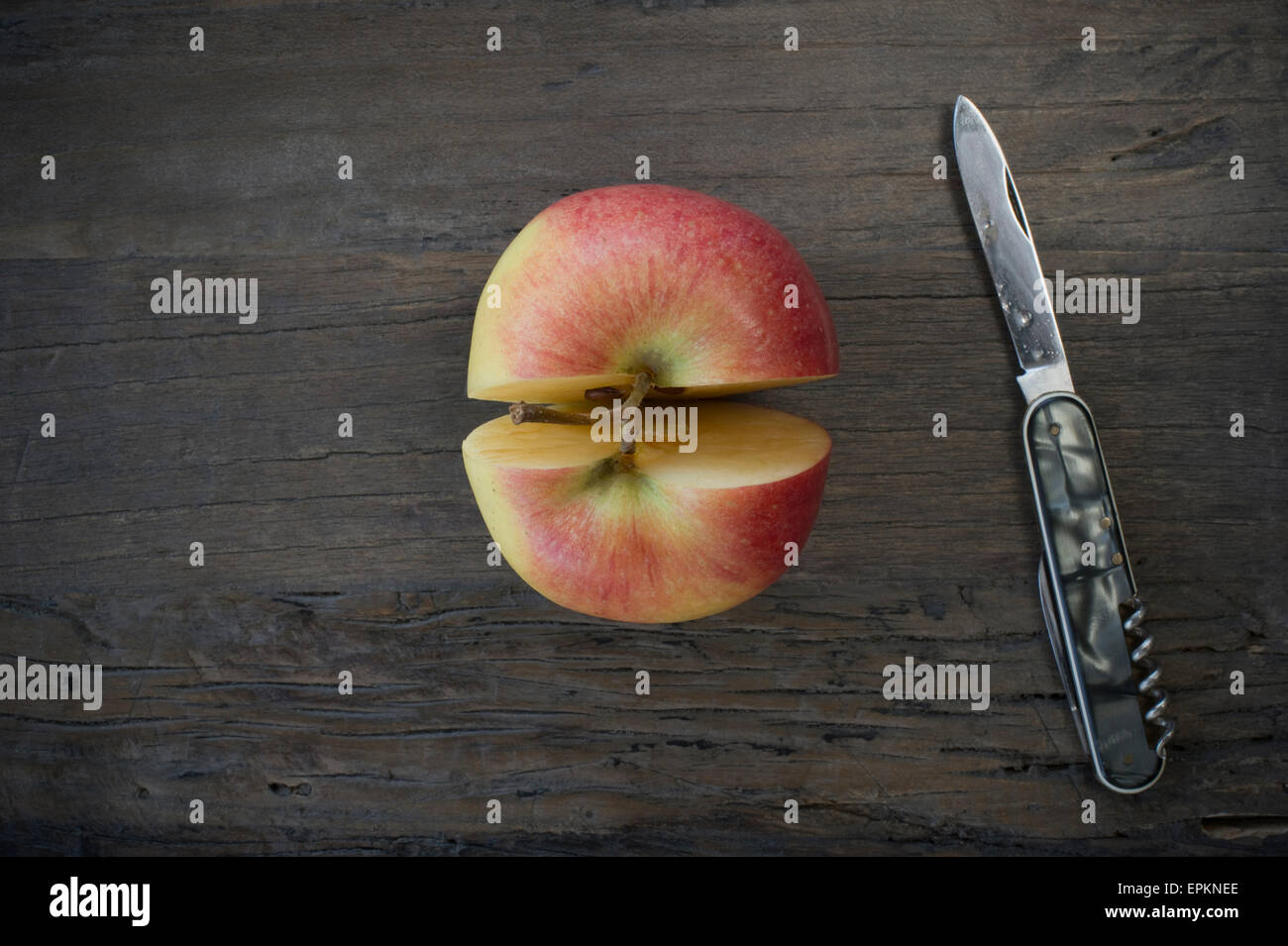 Sliced apple and pocket knife on dark wood Stock Photo - Alamy