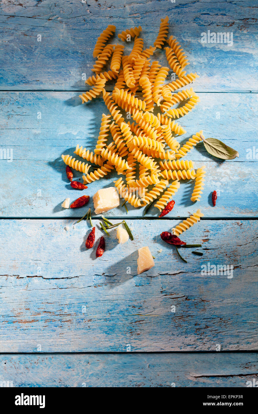 Uncooked Fusilli, chili pods, sage leaves, parmesan and rosmary Stock ...