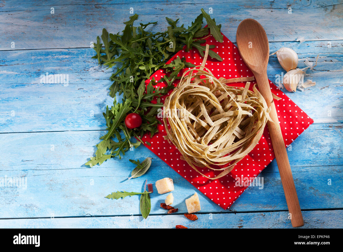 Uncooked Tagliatelle with rocket, parmesan, chili pods, rocket salad ...