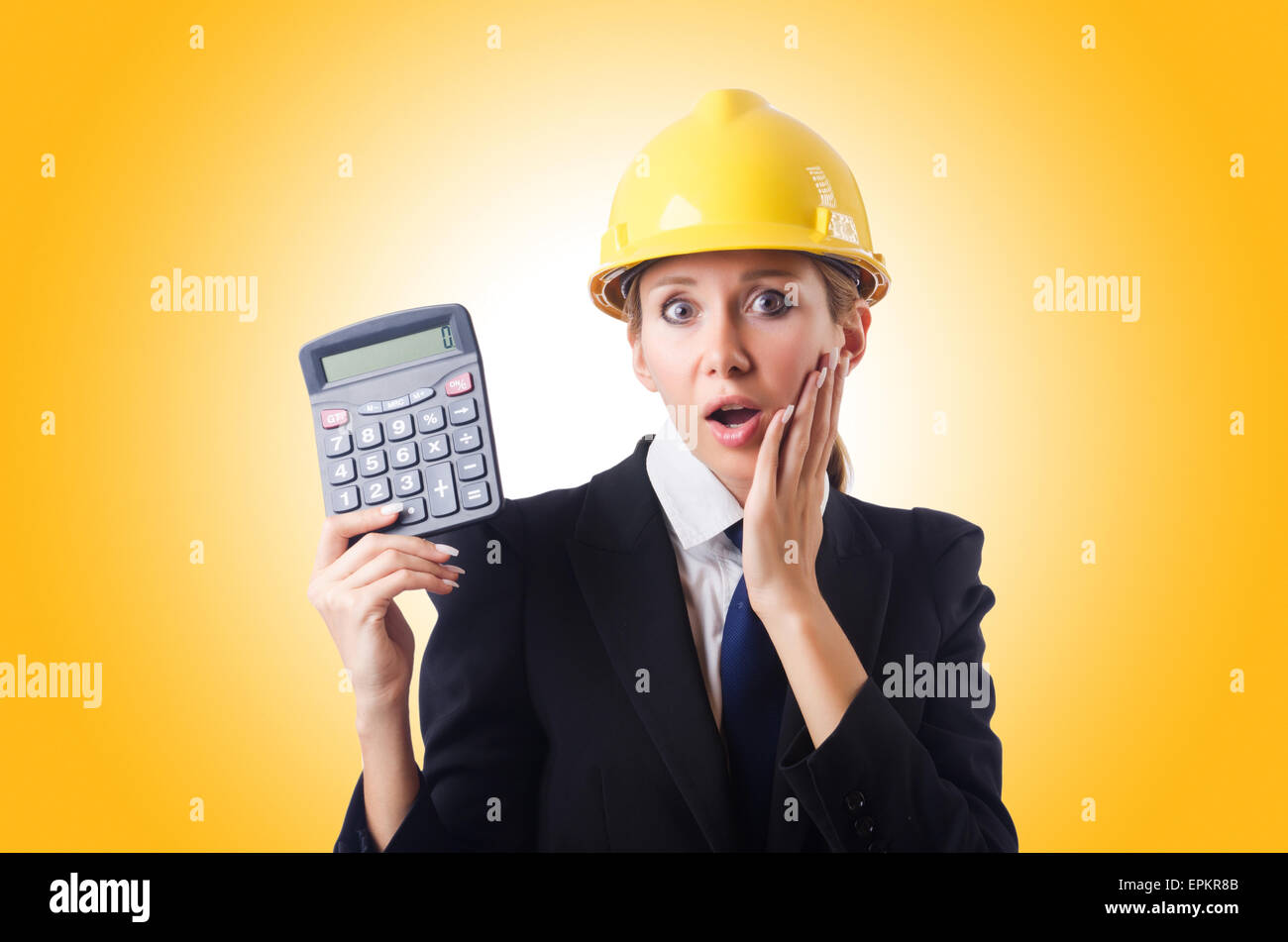 Female construction worker with calculator Stock Photo - Alamy