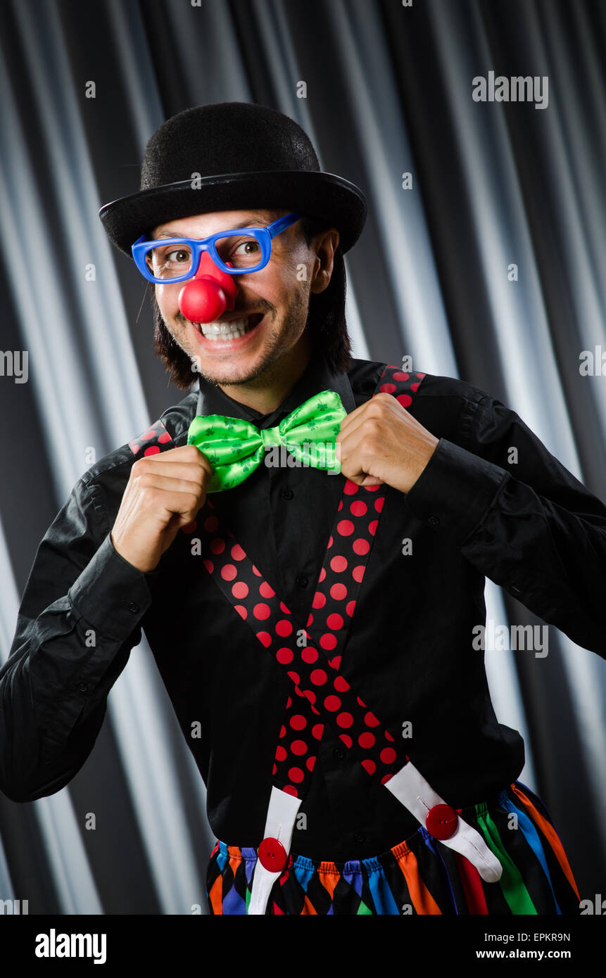 Funny clown in humorous concept against curtain Stock Photo - Alamy