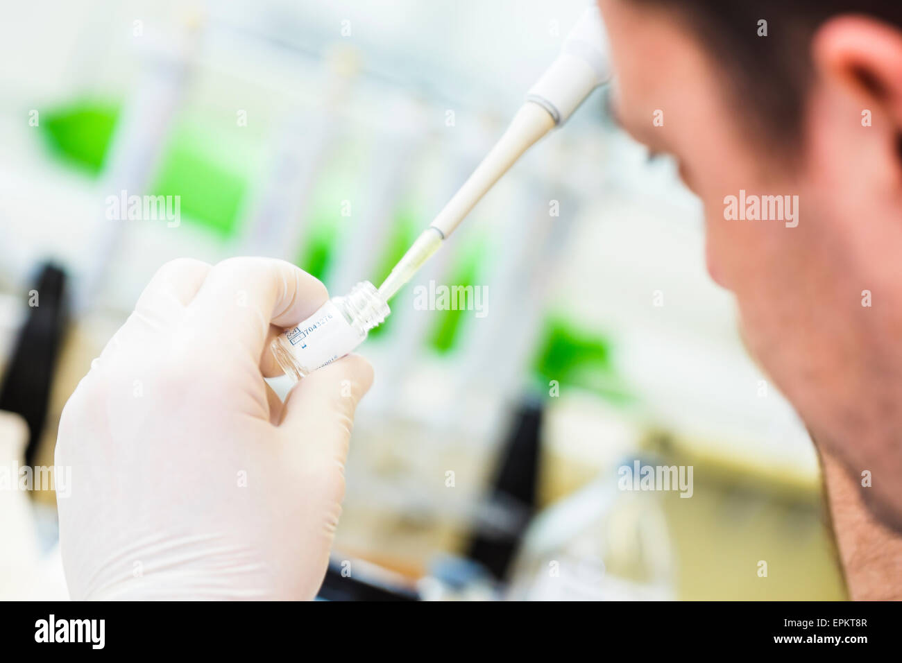 Lab technician analysing blood sample Stock Photo - Alamy