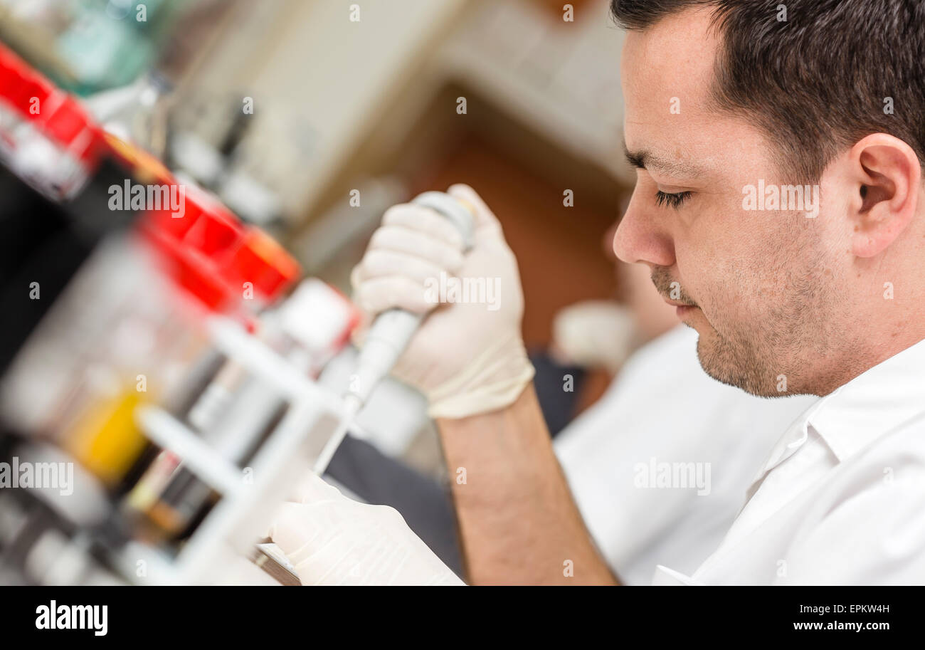 Lab technician analysing blood sample Stock Photo - Alamy