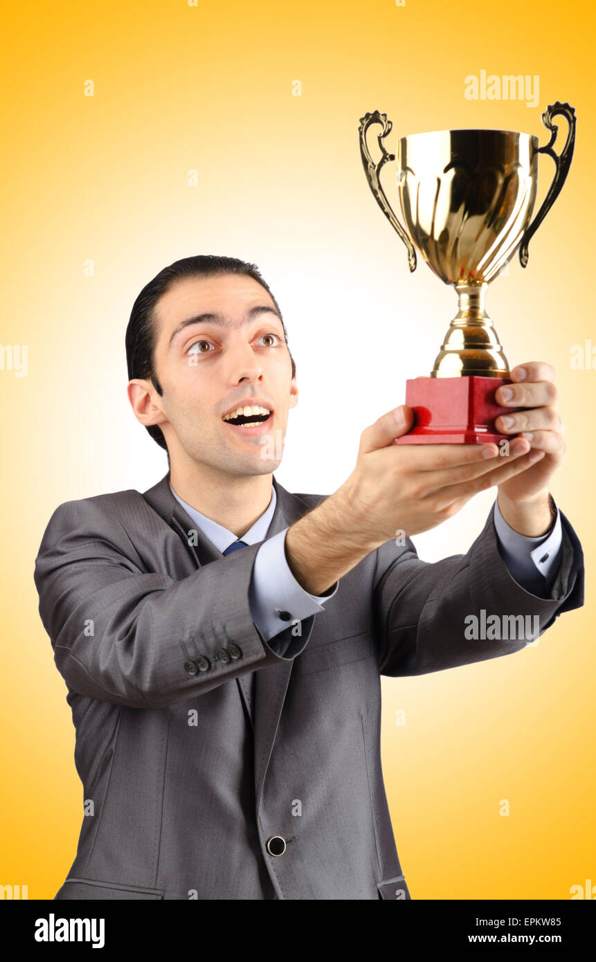 Man being awarded with golden cup Stock Photo - Alamy