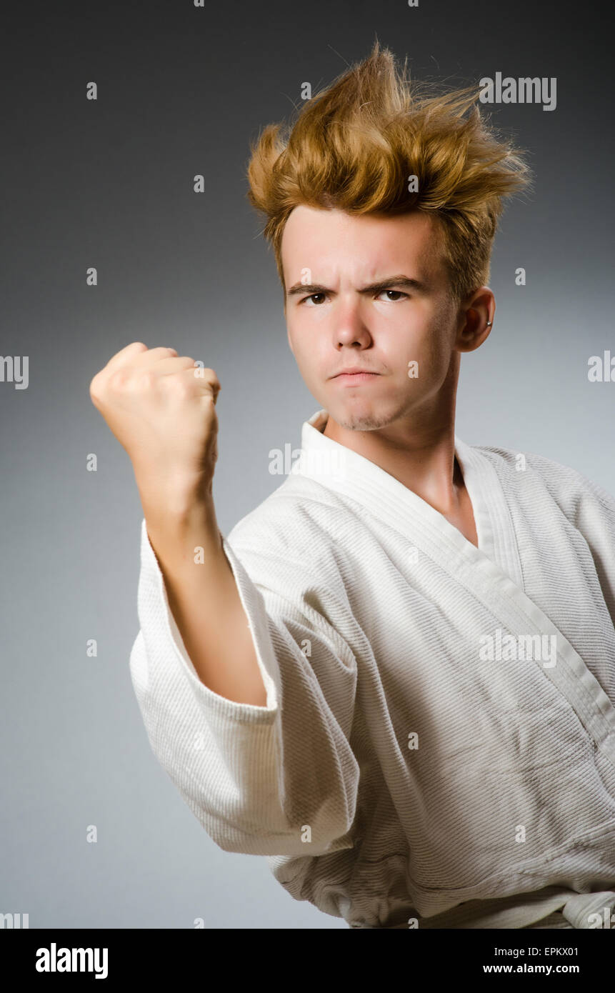 Funny karate fighter wearing white kimono Stock Photo - Alamy