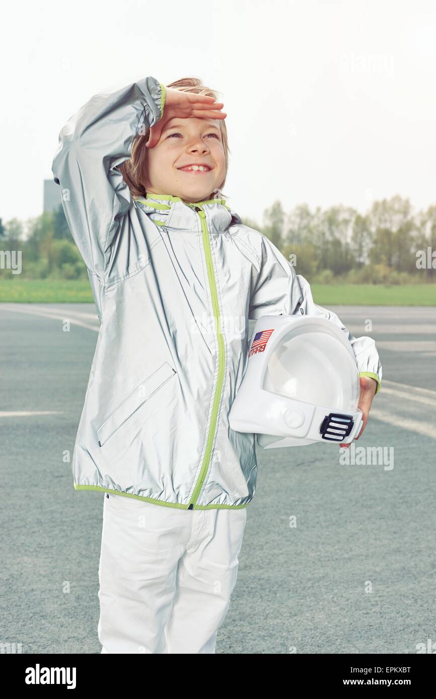 Boy dressed up as spaceman looking up Stock Photo - Alamy