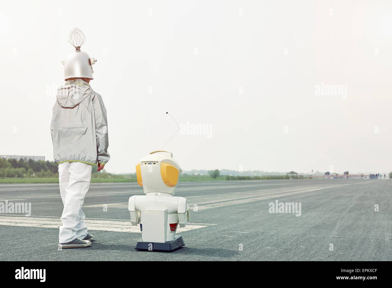 Boy dressed up as spaceman with robot Stock Photo - Alamy