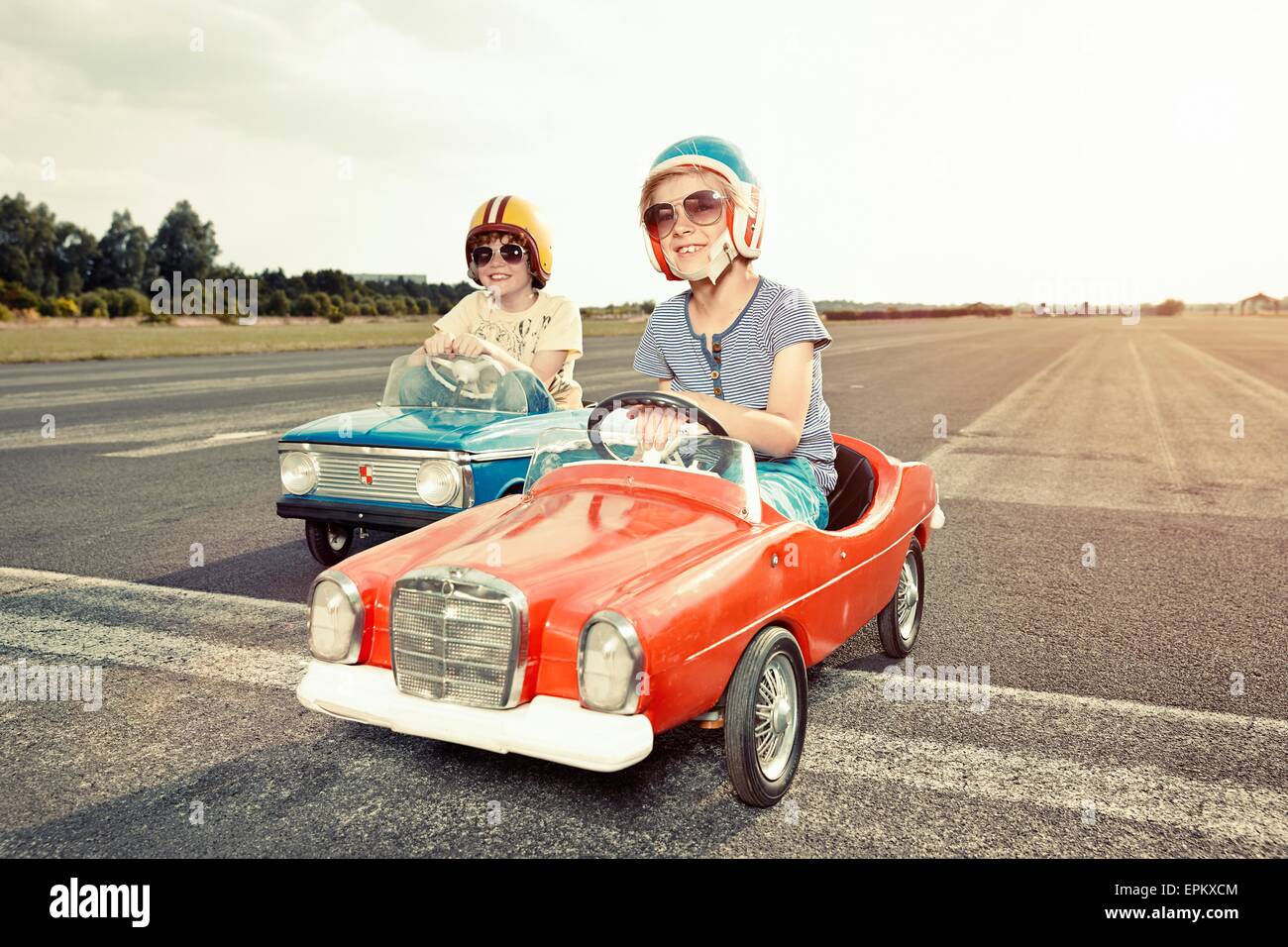 Two boys in pedal cars crossing finishing line on race track Stock ...