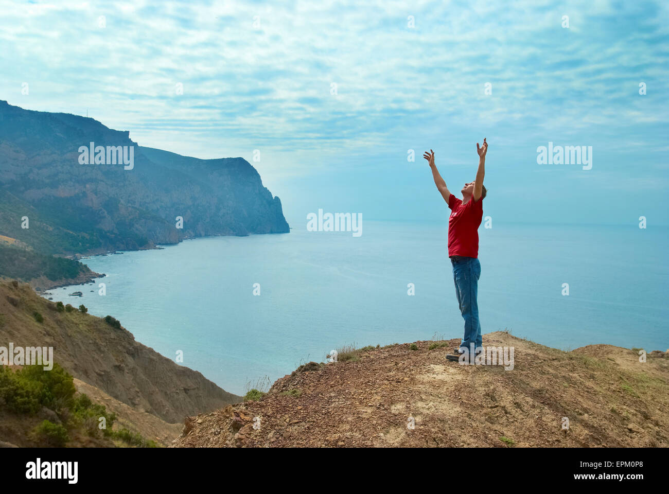 Happy man on the cliff Stock Photo - Alamy