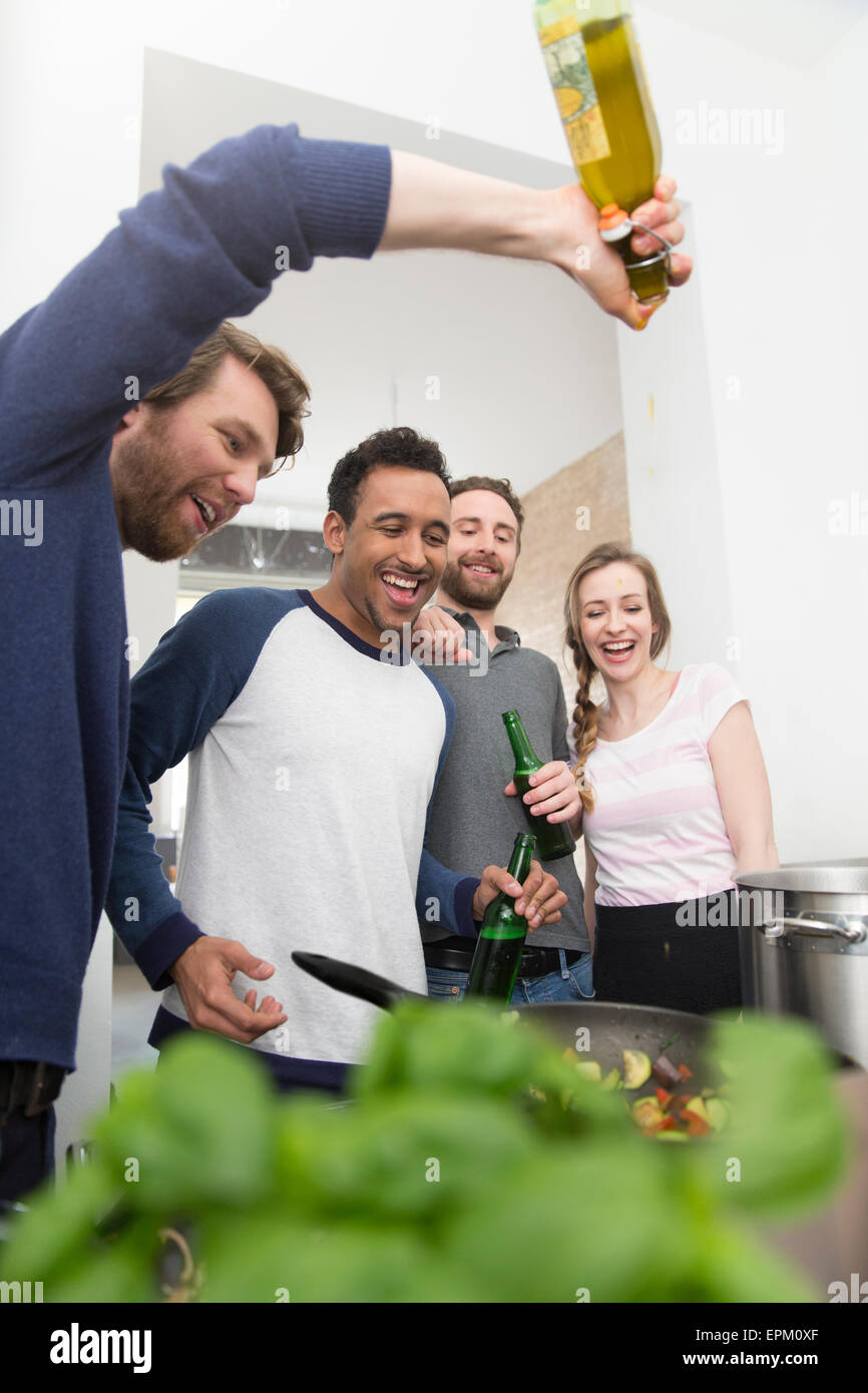Happy friends cooking together Stock Photo - Alamy