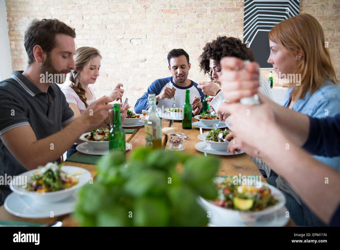 Friends eating together Stock Photo - Alamy