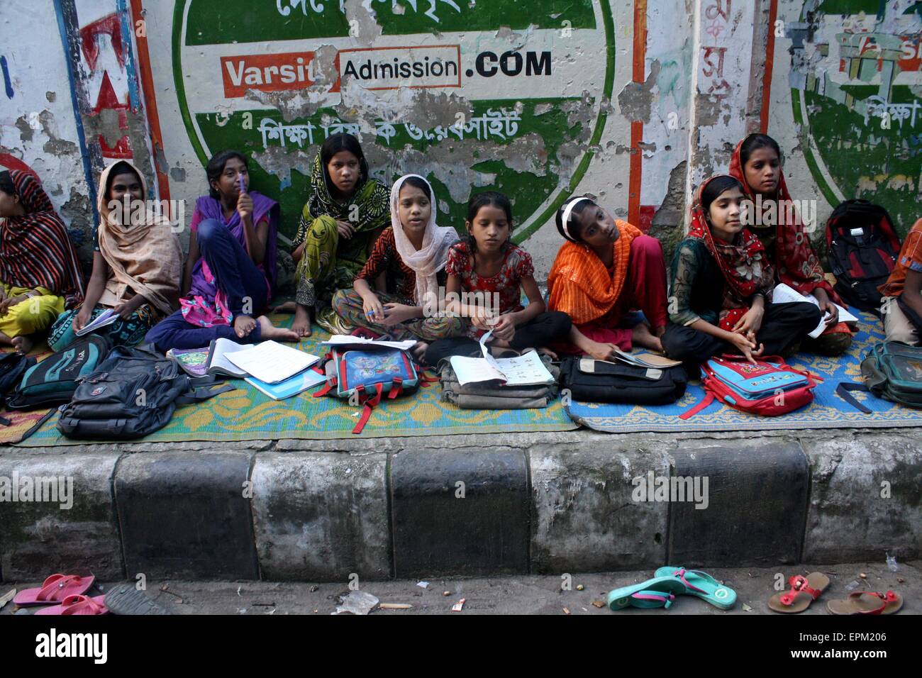 Bangladeshi street children study at the roadside at Poribug in Dhaka ...