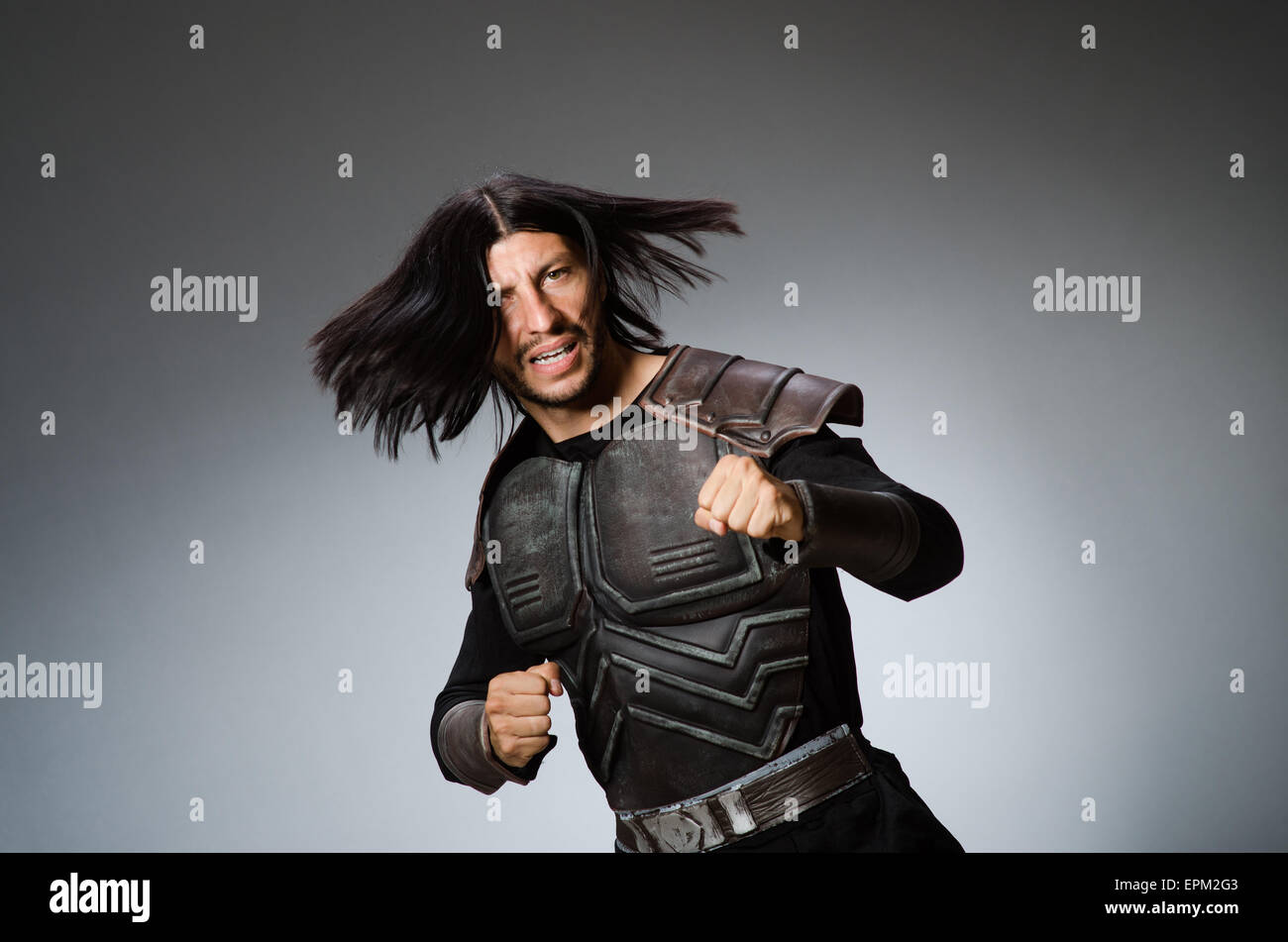 Angry warrior against dark background Stock Photo - Alamy