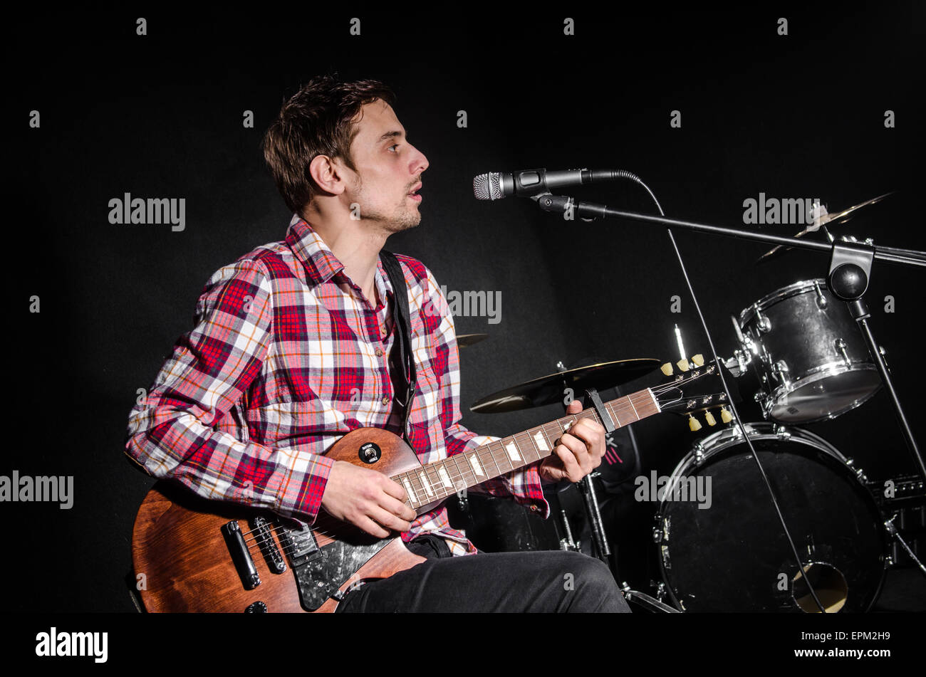 Man with guitar during concert Stock Photo - Alamy